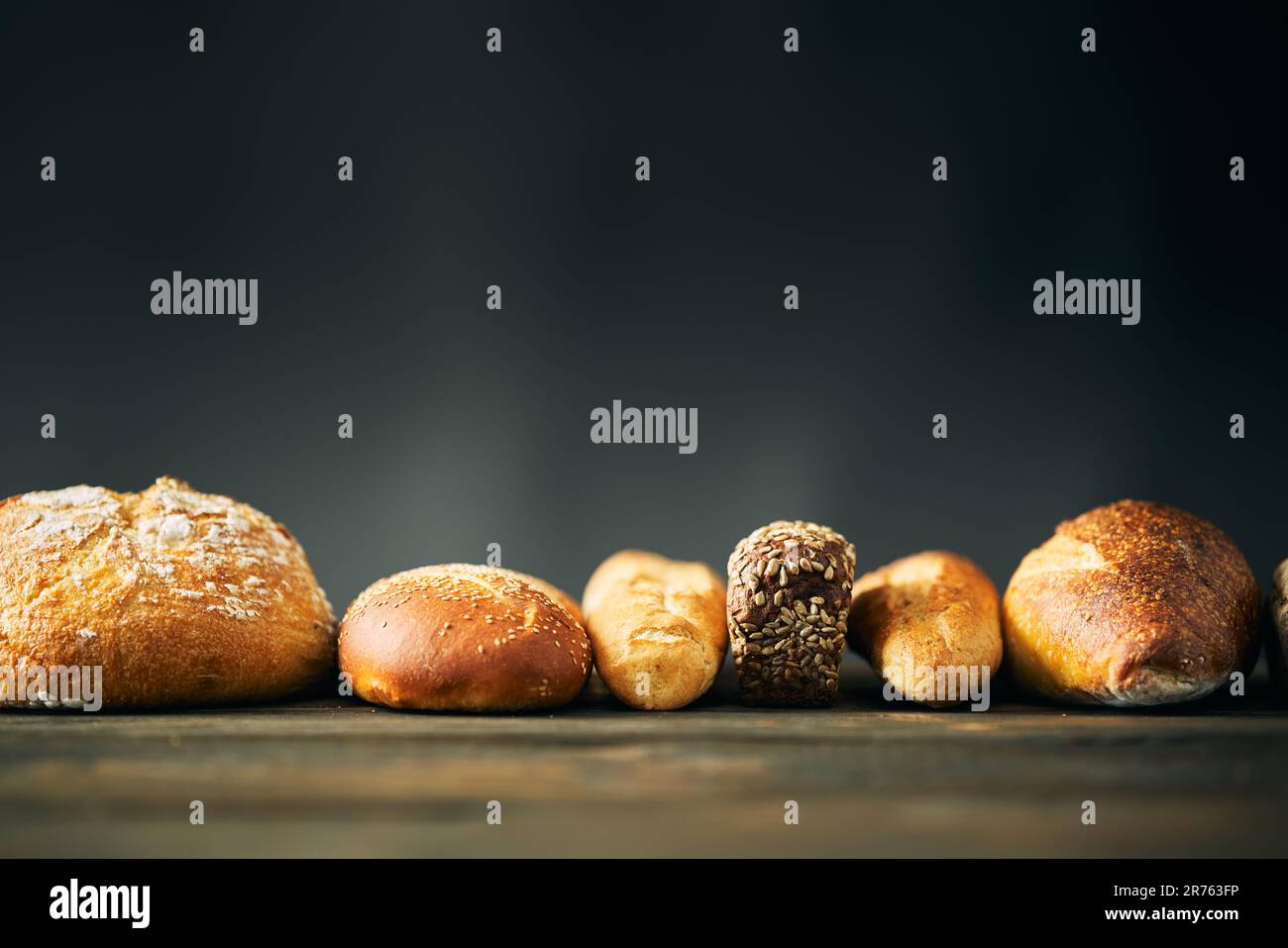 Different types of bread loaves close up with copy space. Bakery, food ...