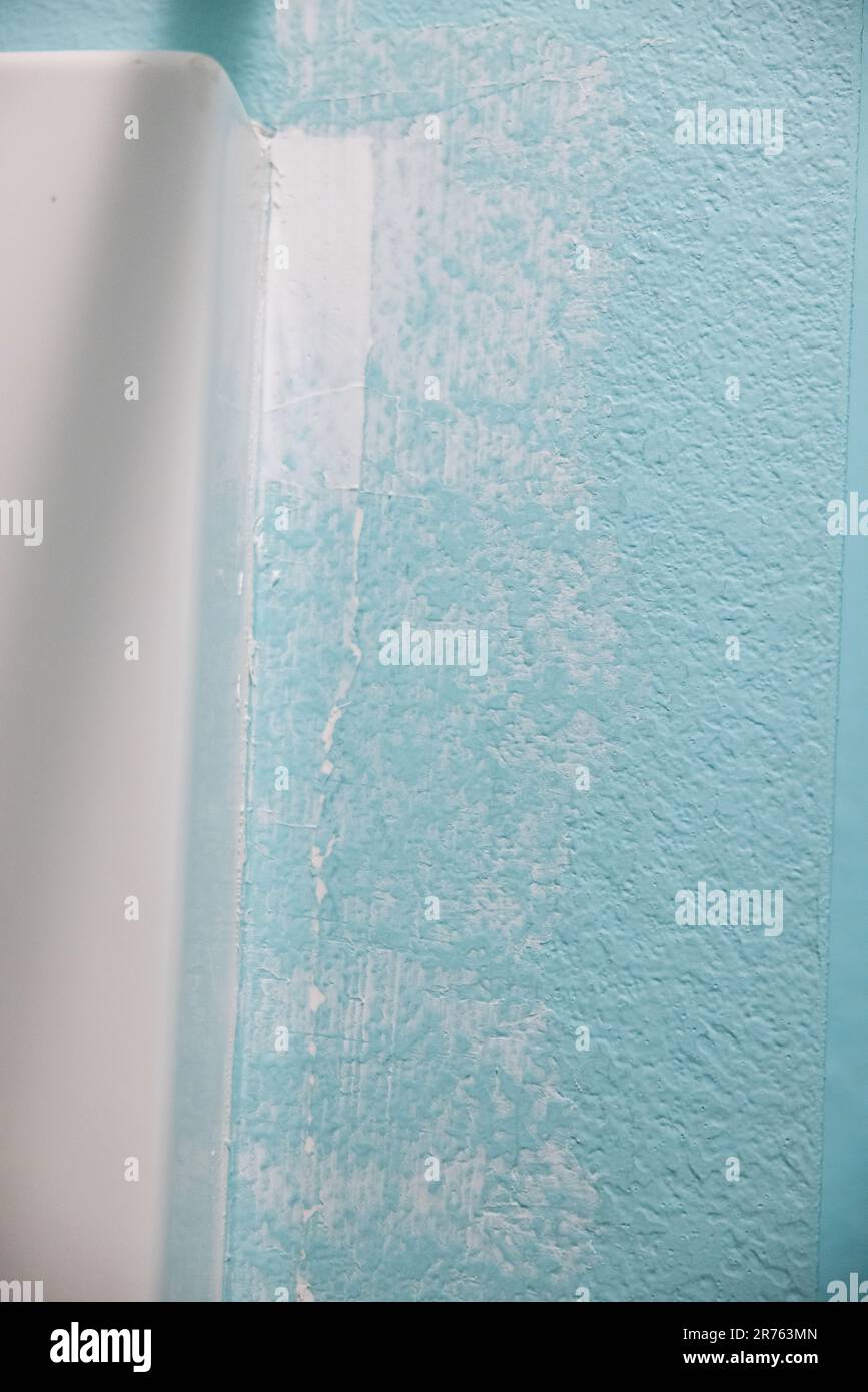 A crack in a bathroom wall between the textured wall and the shower ...