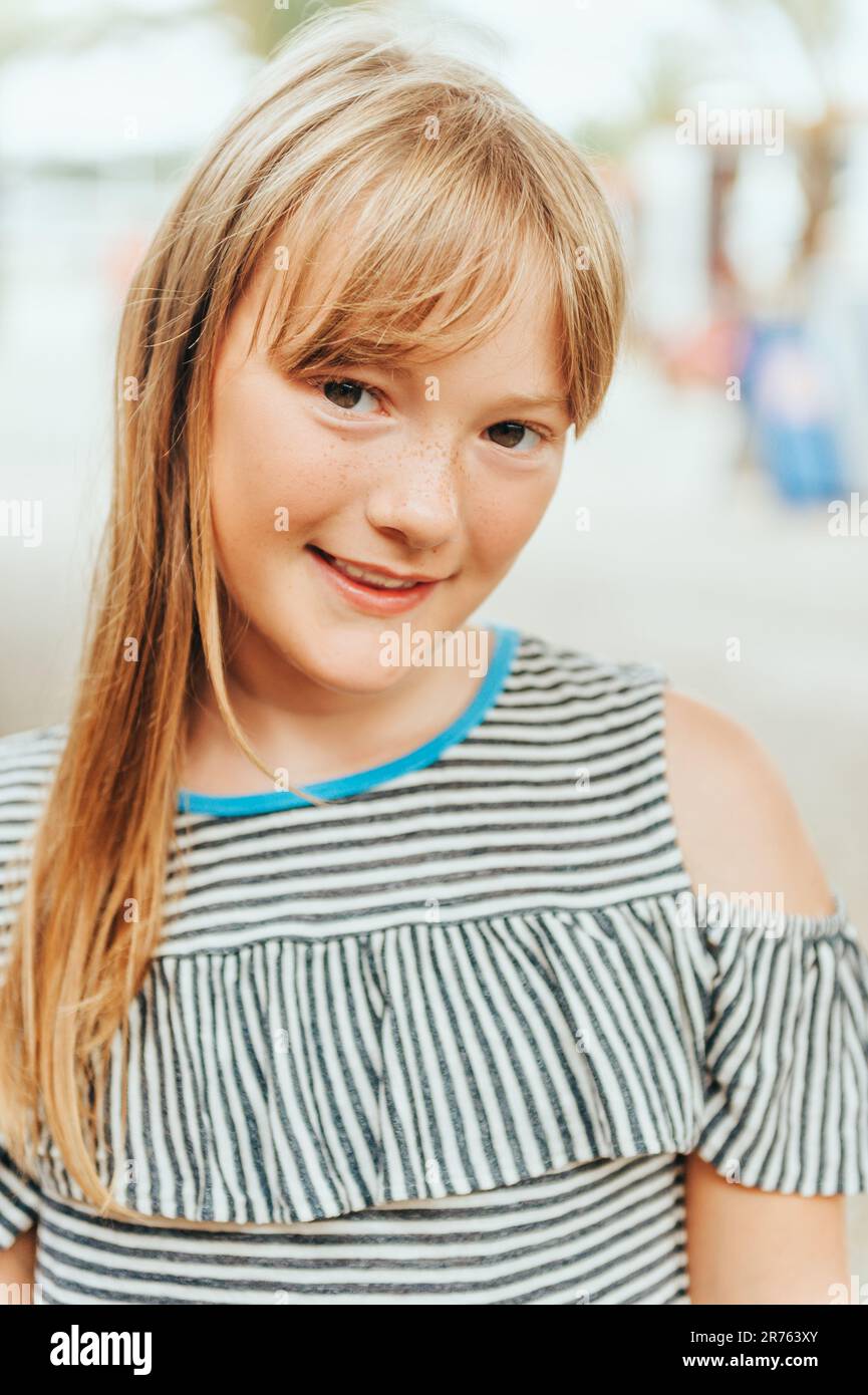 Outdoor portrait of cute preteen 10 year old girl wearing cold ...