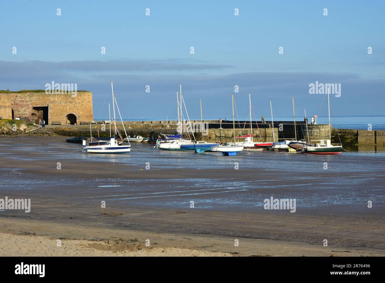 Beadnell Bay, boats outside the harbour, Northumberland Stock Photo - Alamy