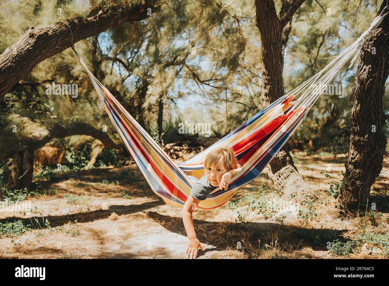 Funny little boy playing in hammock, child resting in garden Stock ...