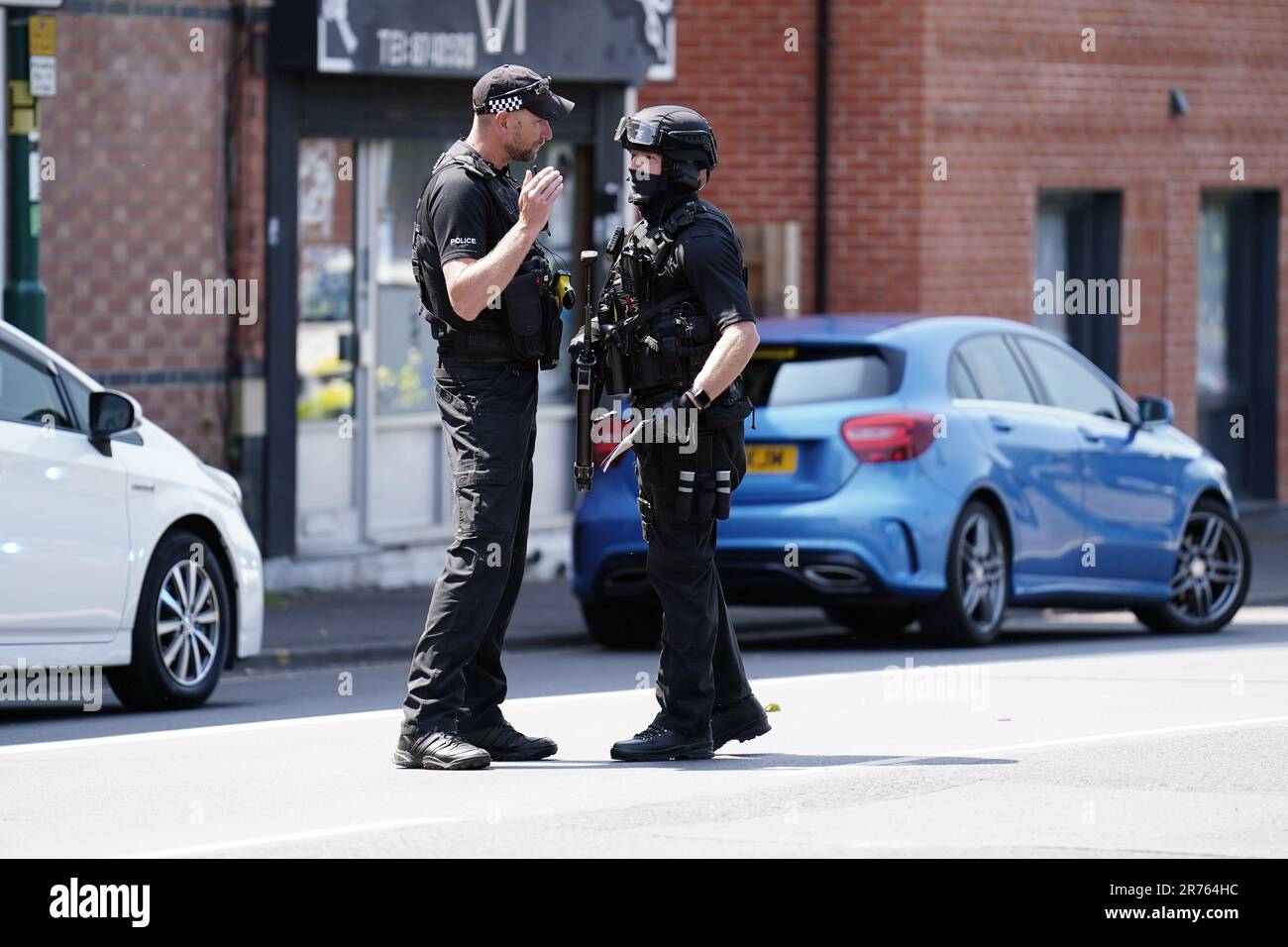 Armed police officers on Ilkeston Road in Nottingham, as three people ...