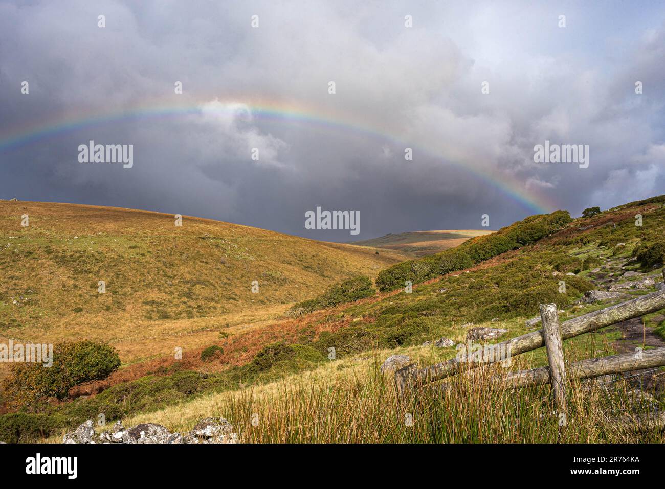 Heavy clouds with rainbow in Dartmoor National Park Stock Photo - Alamy