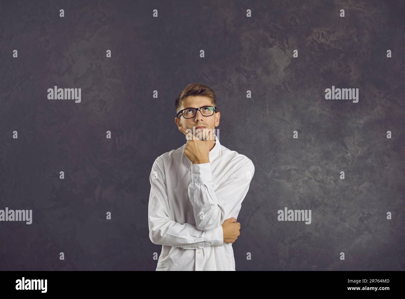 Confused man thinking, doubting, trying to make choice or answer ...