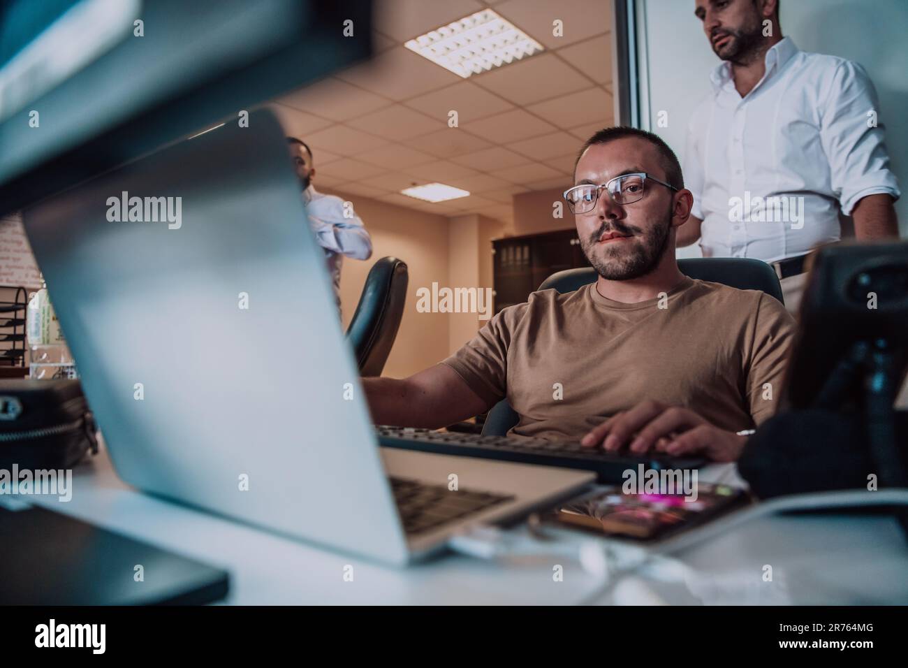 Programmers engrossed in deep collaboration, diligently working ...