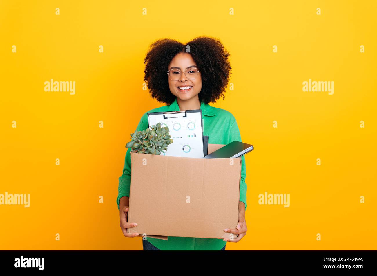 New job. Happy brazilian or african american woman, holding cardboard ...