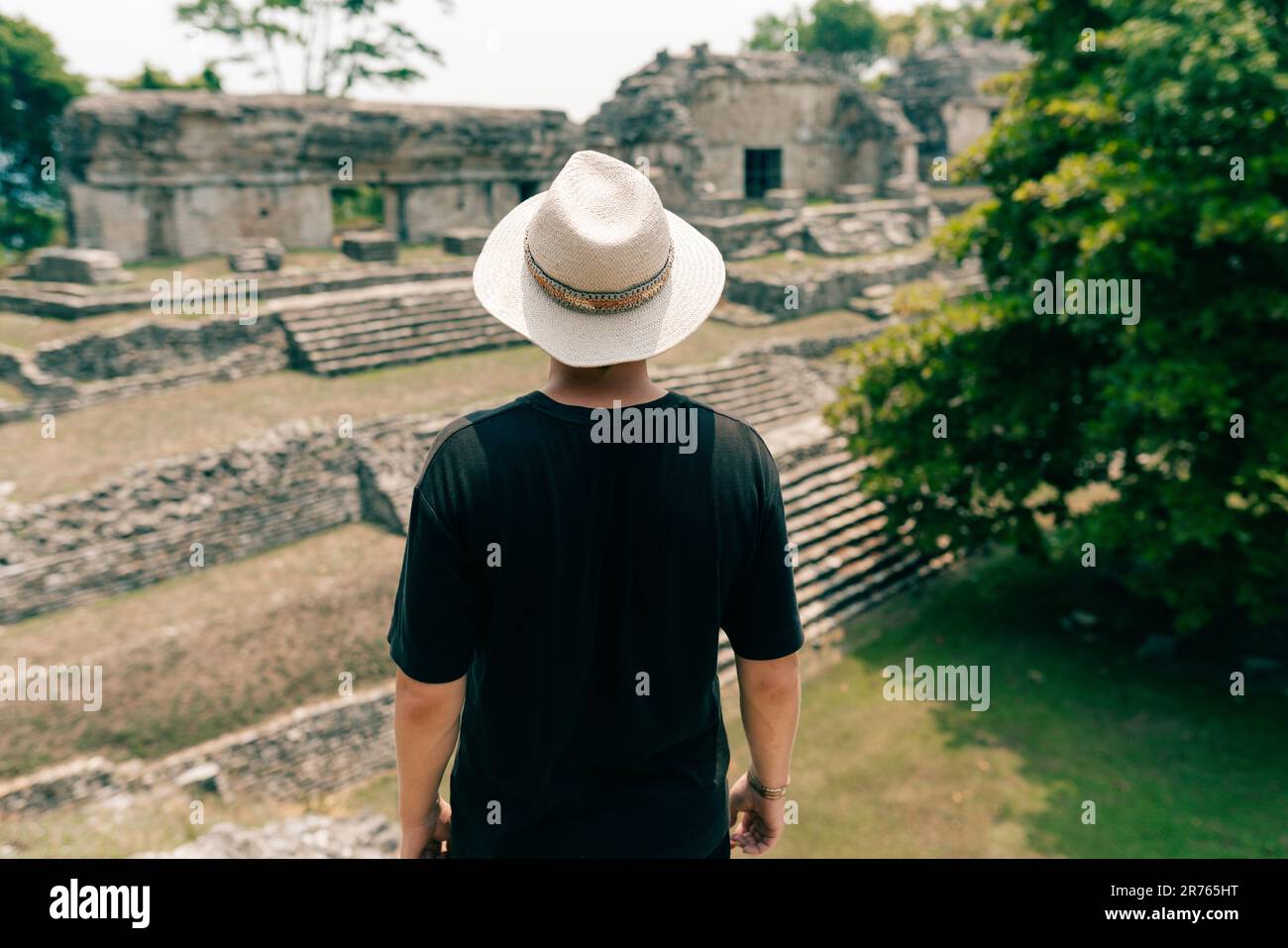 Hiker man with a hat looking at ancient Mayan ruins. High quality photo ...