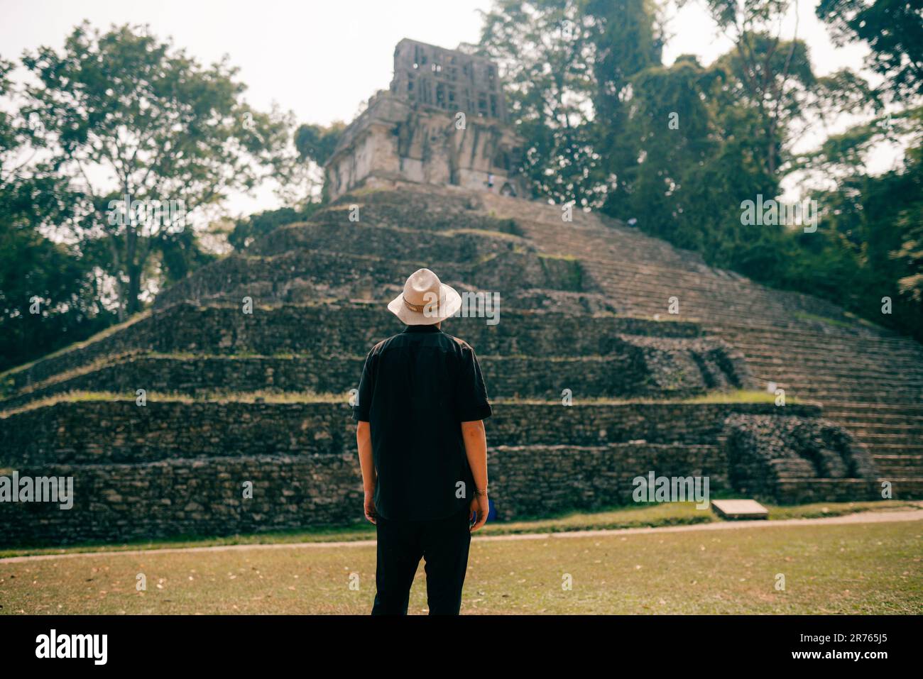 Hiker man with a hat looking at ancient Mayan ruins. High quality photo ...