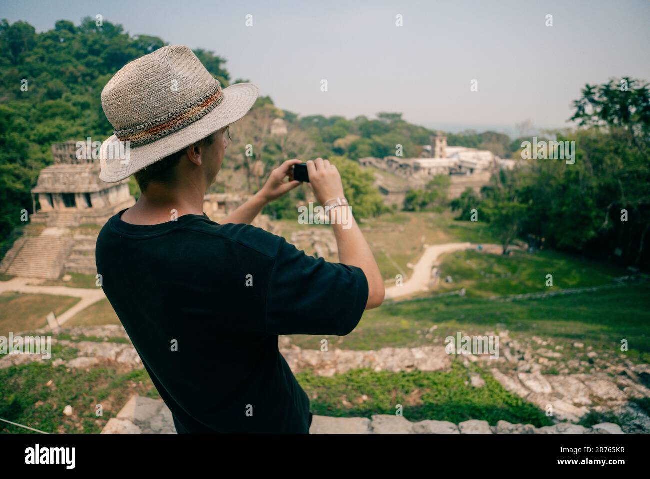 Hiker man with a hat looking at ancient Mayan ruins. High quality photo ...
