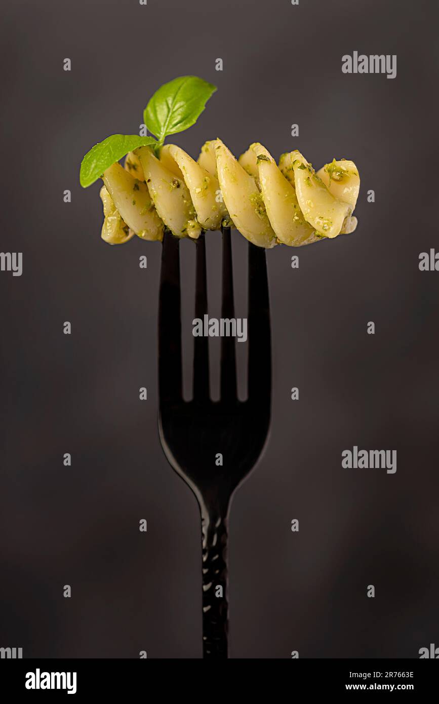 Macro food photography of giant fusilli, pasta, basil, pesto, sauce ...