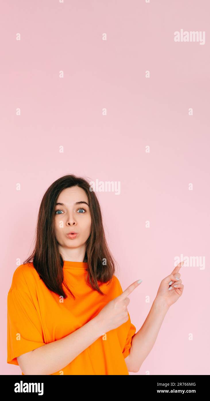 Engaging Playfulness: Humorous Woman Pointing Two Fingers at Empty ...