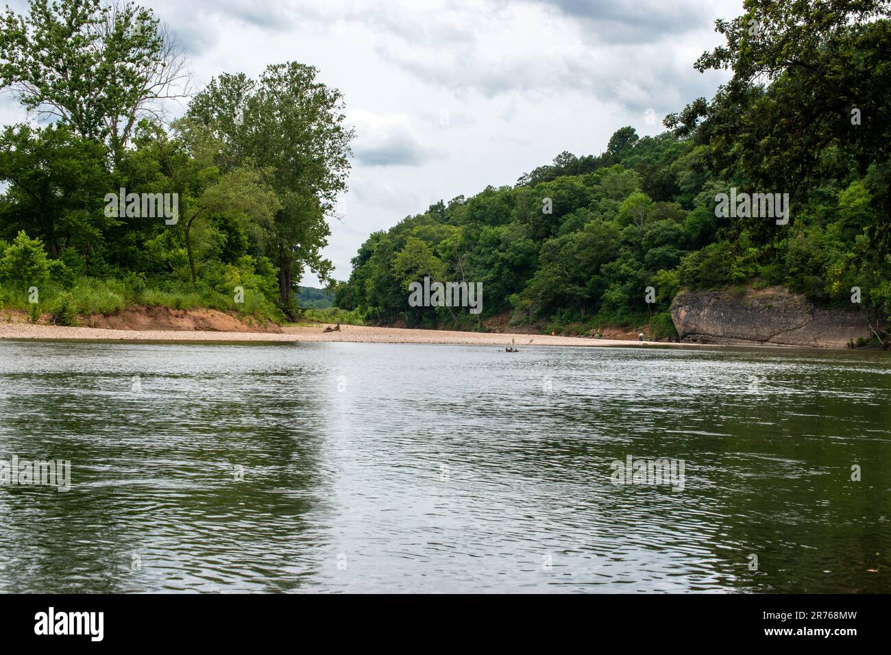 A bright sunny day makes a beautiful peaceful river scene. Green trees ...