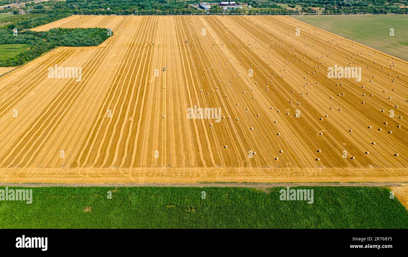 Above high view over two tractors as they pulling round baler, machines ...