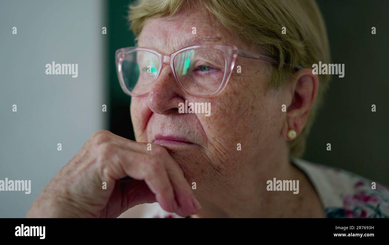 Pensive senior woman close-up face. 80s elderly female person in deep ...