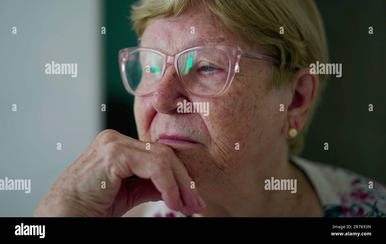 Pensive senior woman close-up face. 80s elderly female person in deep ...
