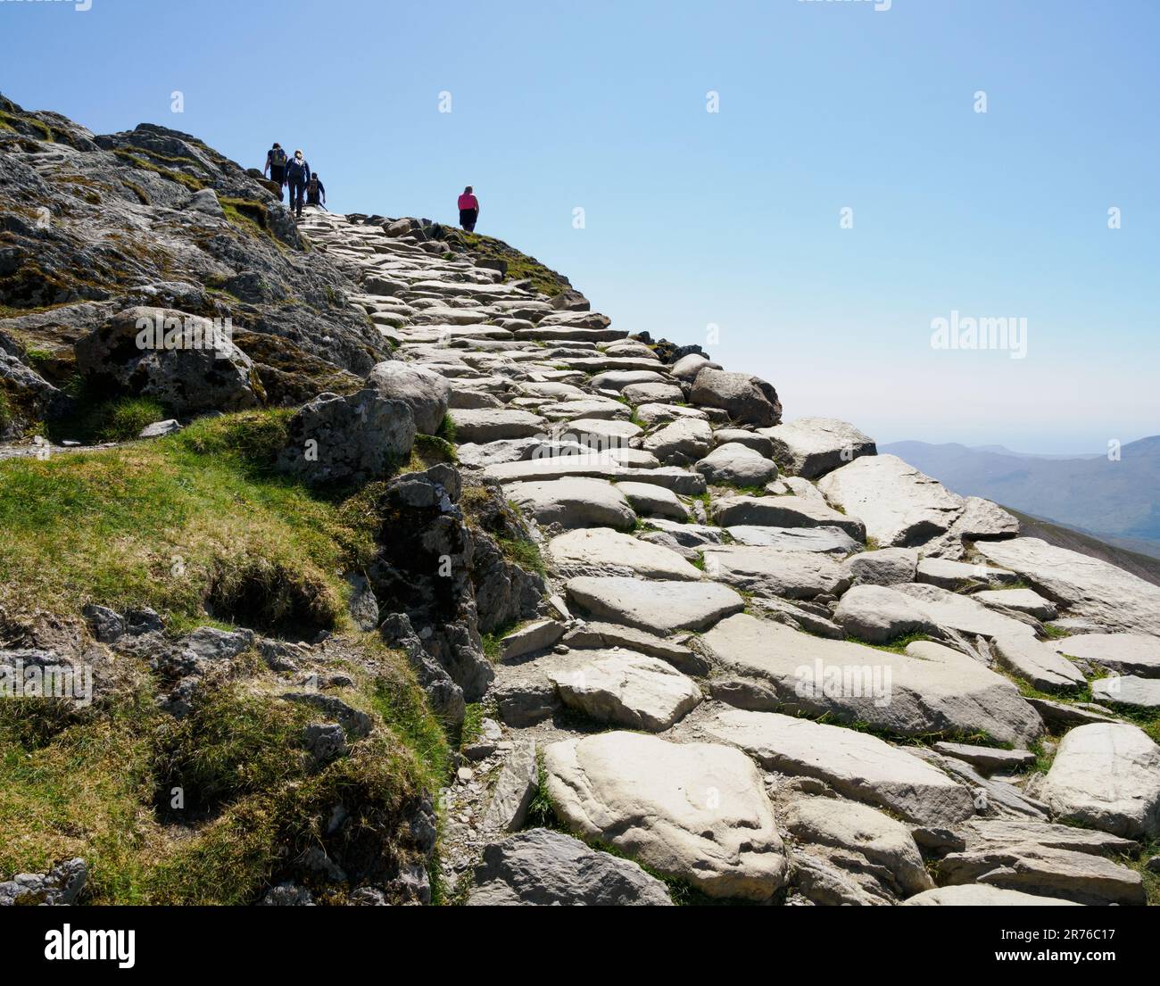 Walkers making the final ascent to the summit cone of Snowdon Yr ...