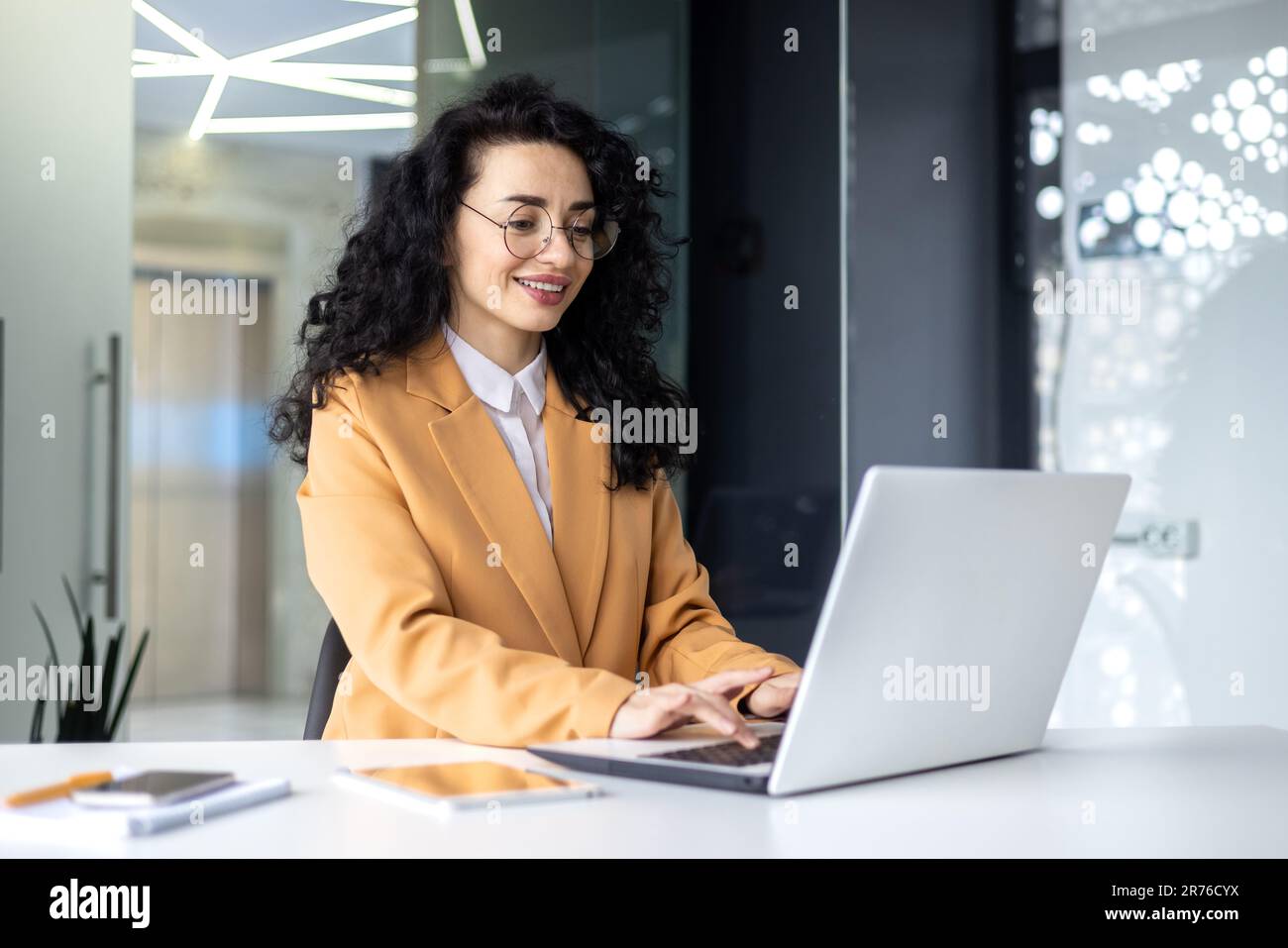 Portrait of mature successful businesswoman at workplace inside office ...