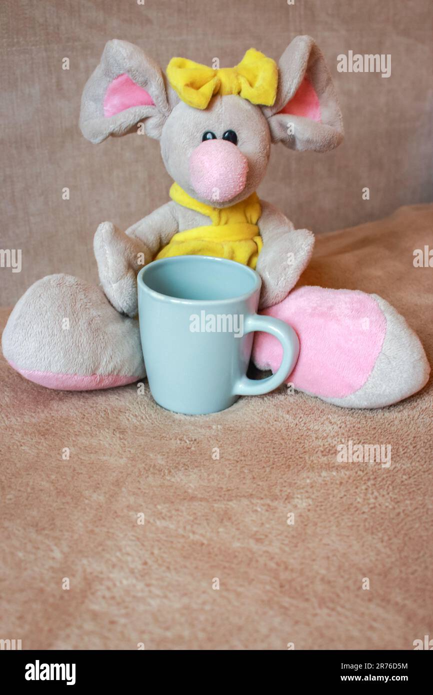 Cute mouse toy with tea cup sitting on sofa. Soft animal toy. Good ...