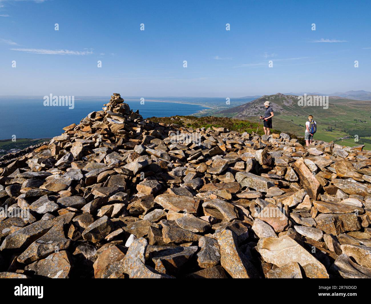 Walkers approaching the summit cairn of Tre'r Ceiri on Yr Eifl on the ...