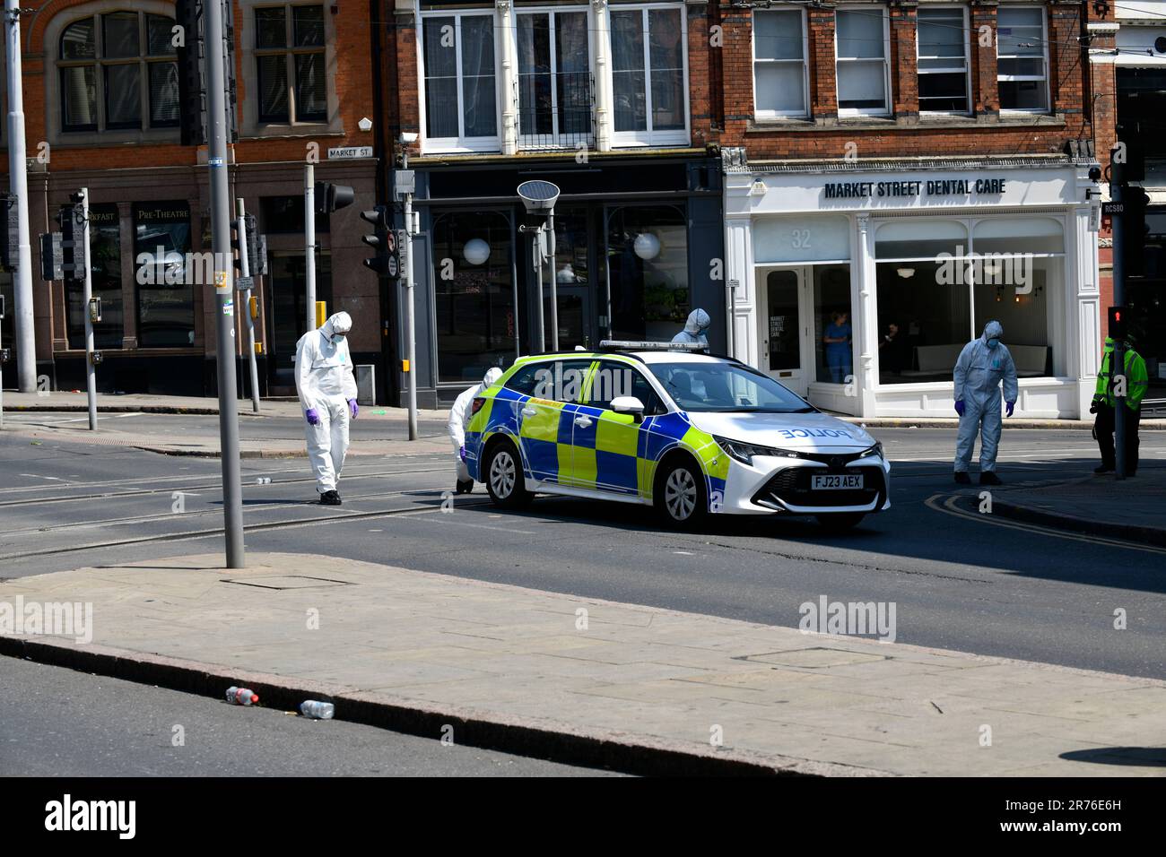 Forensic police officers search the local area. Nottingham van attack ...