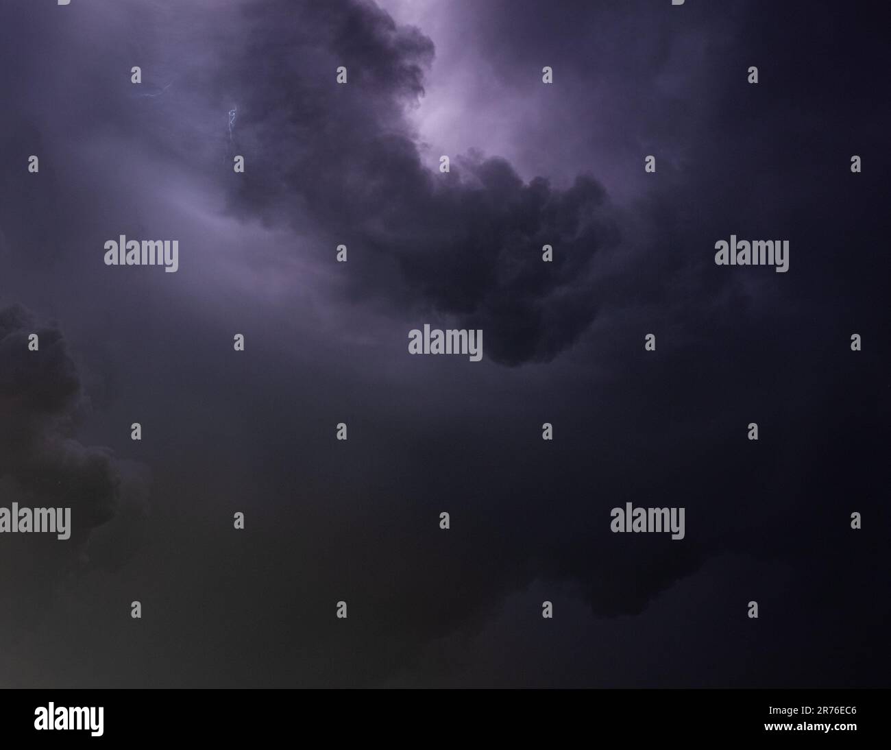A dramatic lightning storm illuminated in the night sky, providing a ...