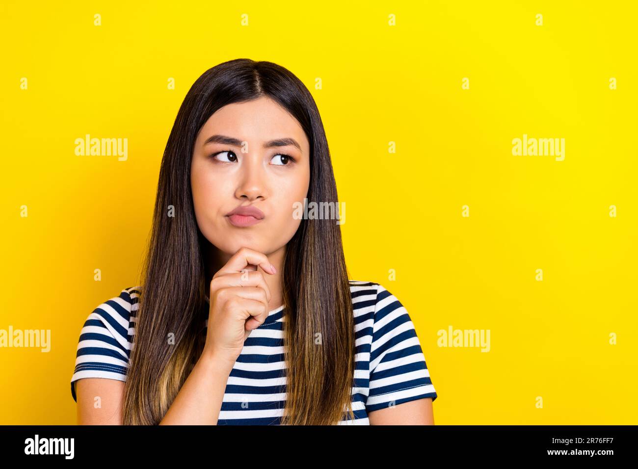 Portrait of funny asian girl looking empty space thinking suspicious ...