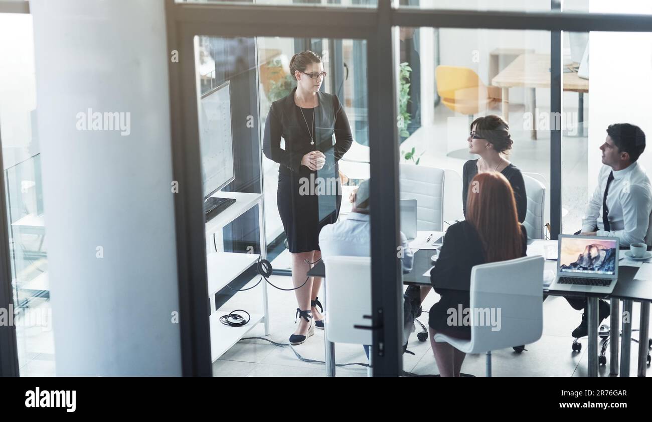 Opening the meeting for questions. an executive giving a presentation ...