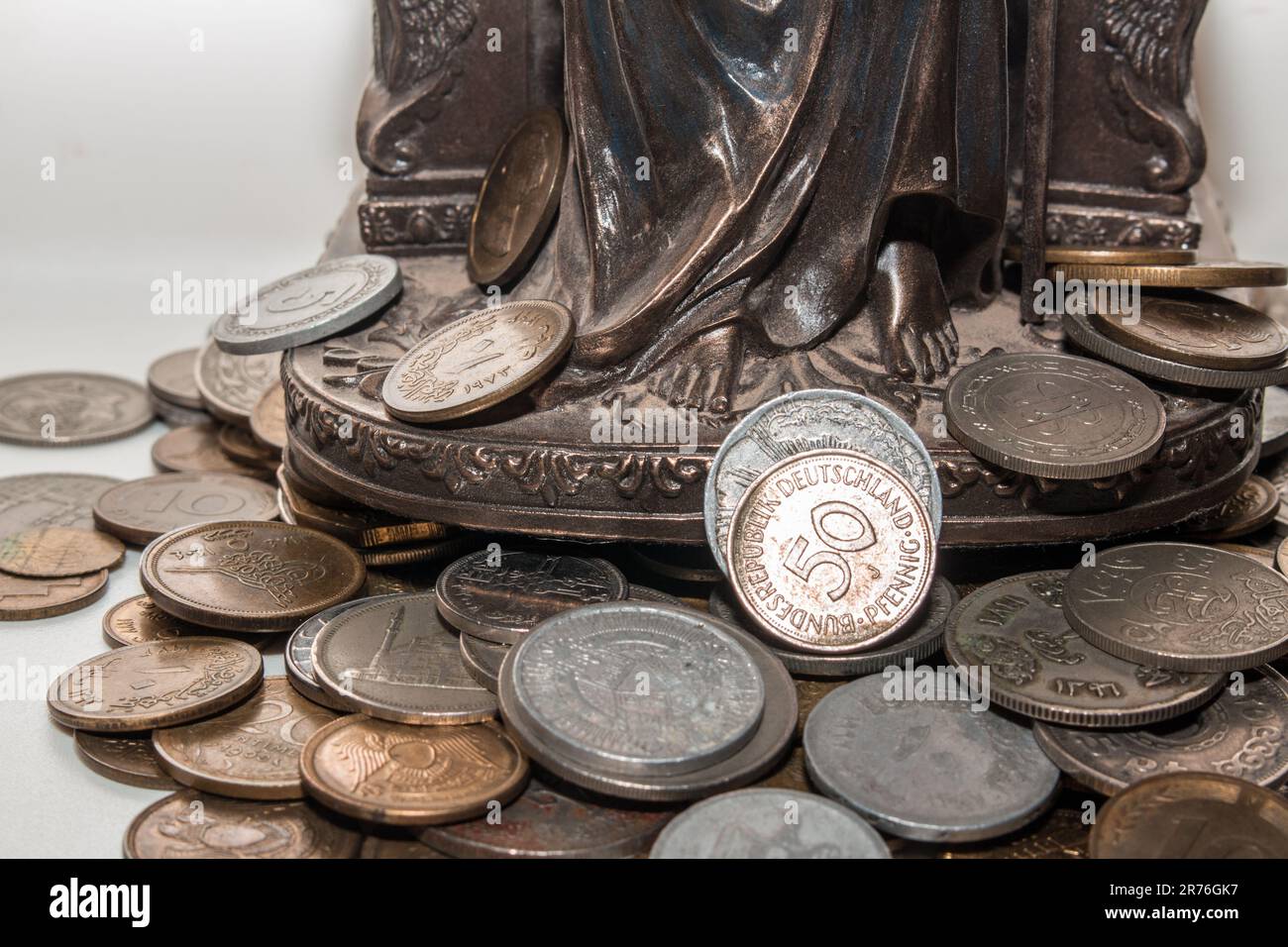 UK London 11 6 2023 :lady justice foot surrounded with Money coins from ...