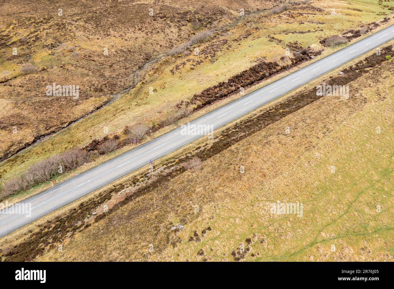 Aerial view of road on the basalt cliff near Staffin, Isle of Skye ...