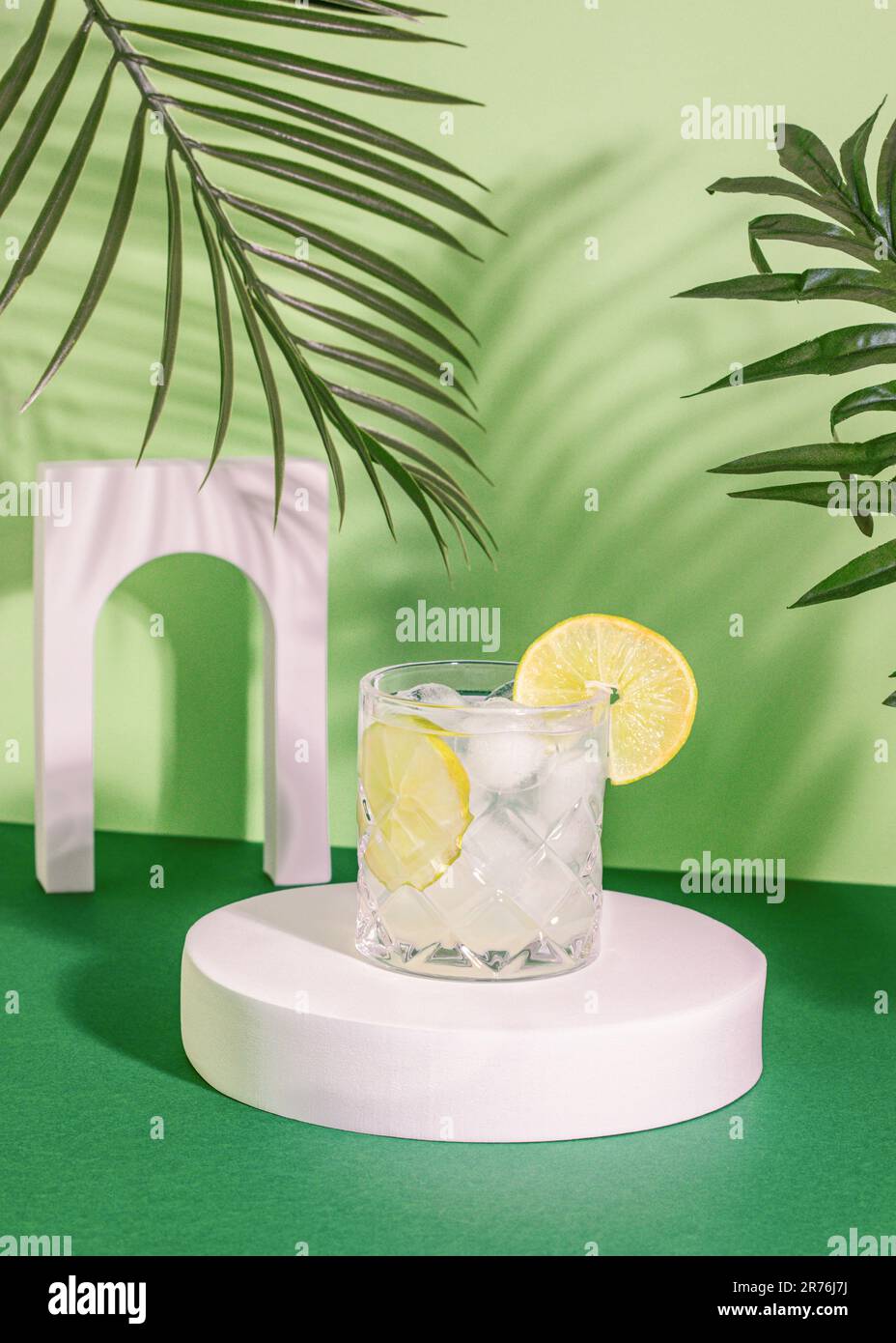 Sparkling transparent crystal glass with ice and slices of lime in ...