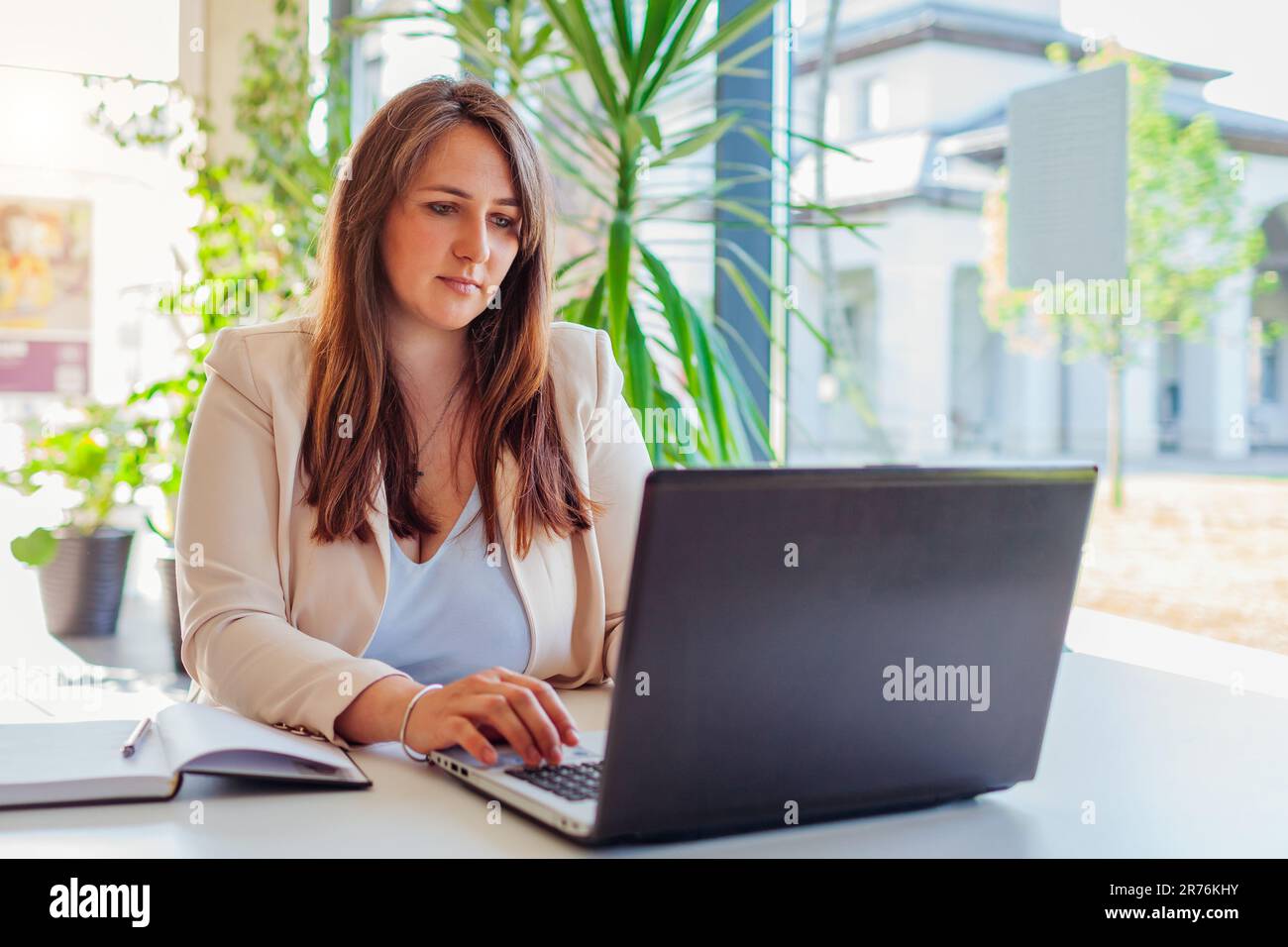 Young female teacher getting ready for lesson working in office using ... Young female teacher getting ready for lesson working in office using ...