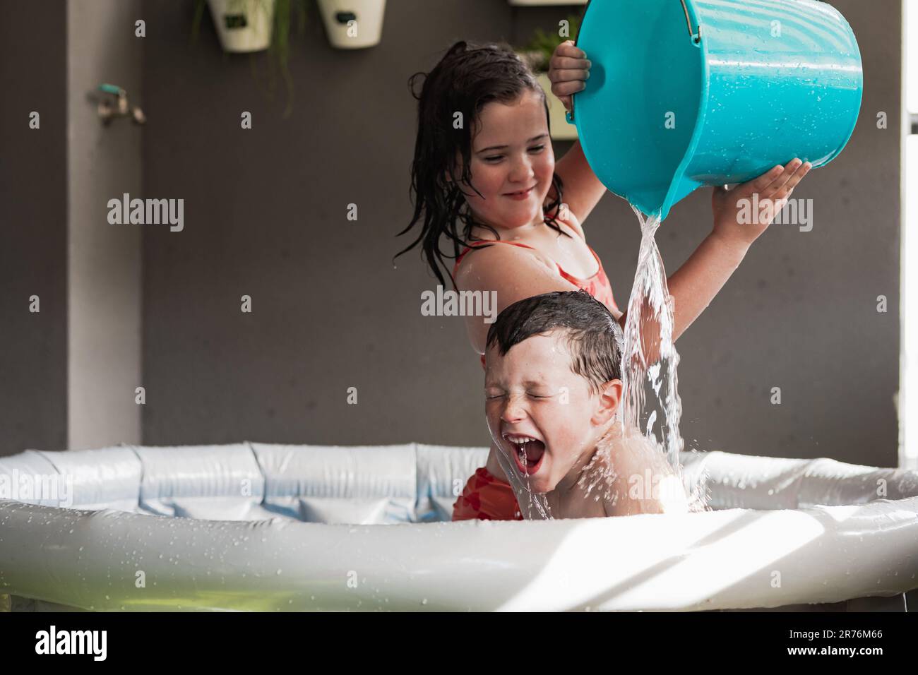 Bucket of water pouring head hi-res stock photography and images - Alamy