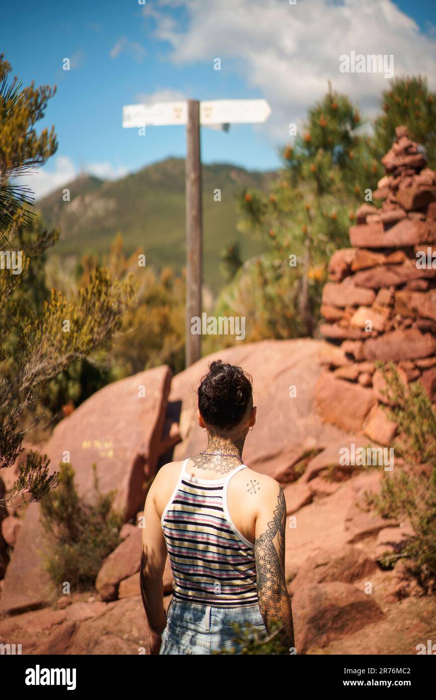 Back view of unrecognizable female in striped casual clothes standing ...