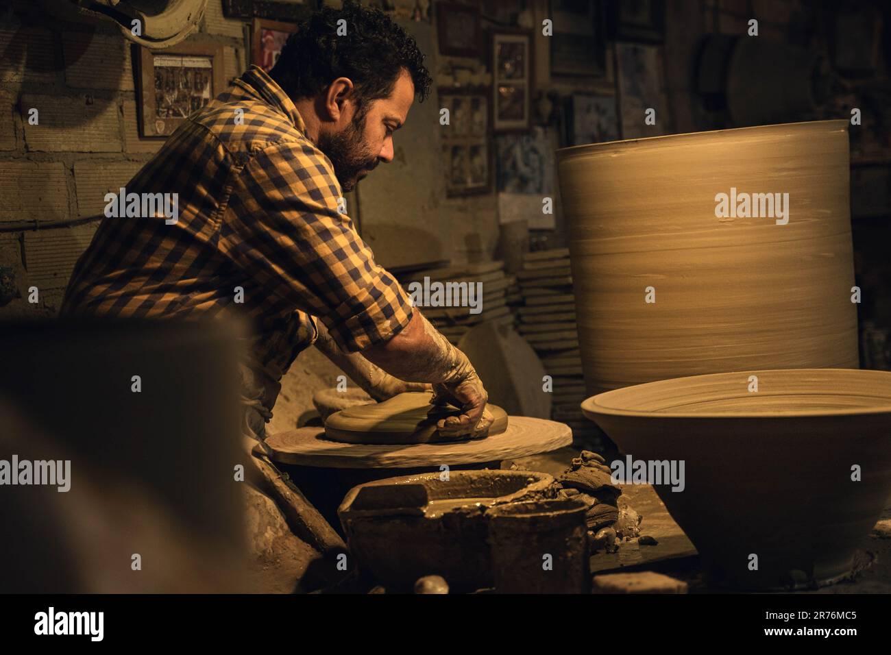 Side view concentrated of middle aged ethnic bearded male master in ...