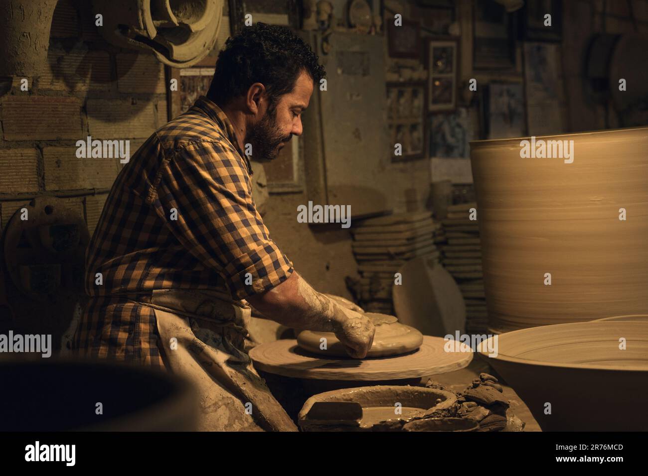 Side view concentrated middle aged ethnic bearded male master in ...