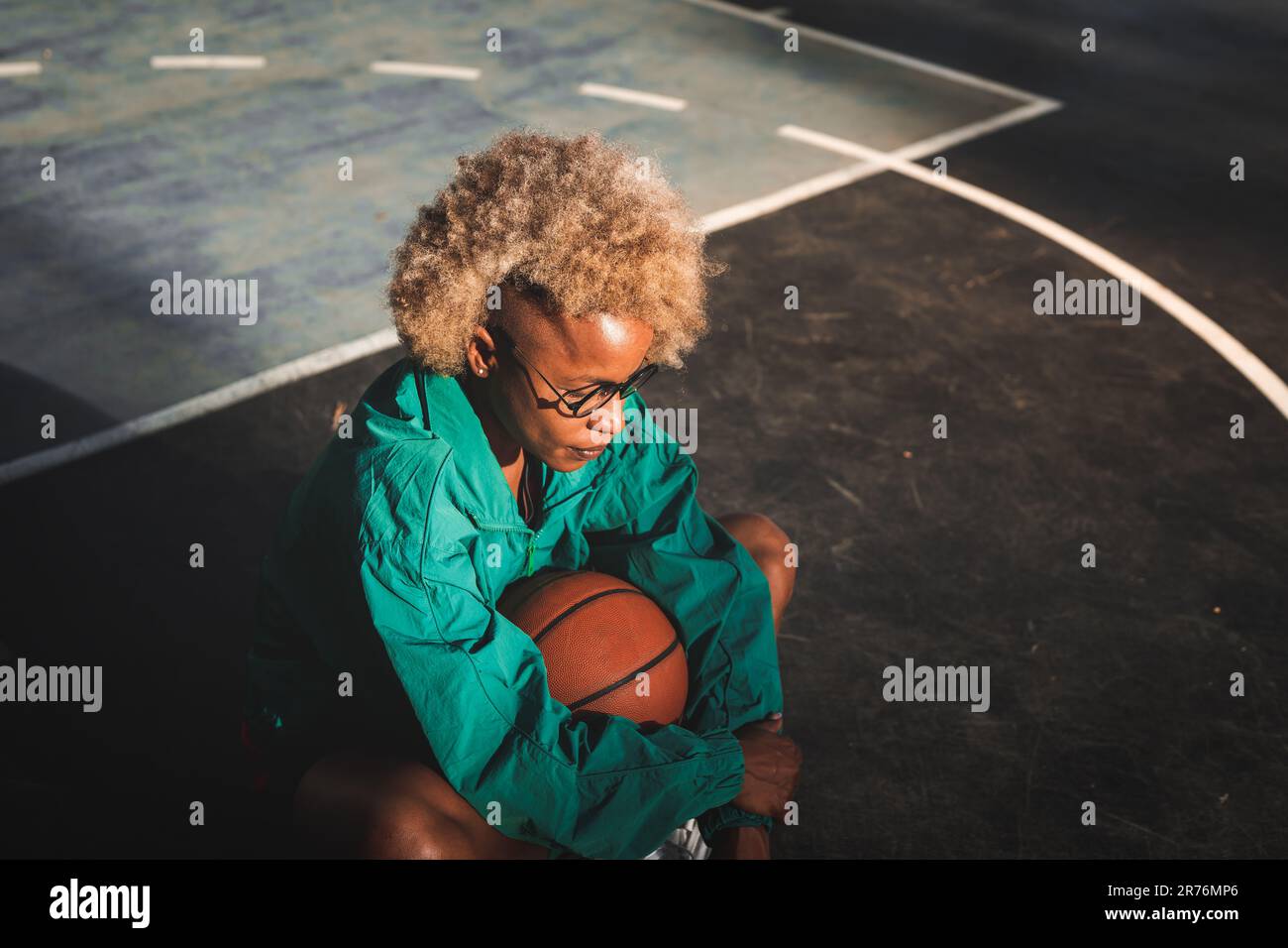 From above pensive young African American female basketball player in ...