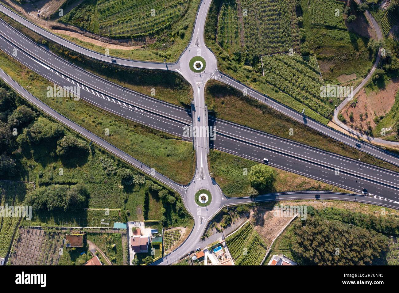 Aerial view of asphalt highway road going through lush green trees ...