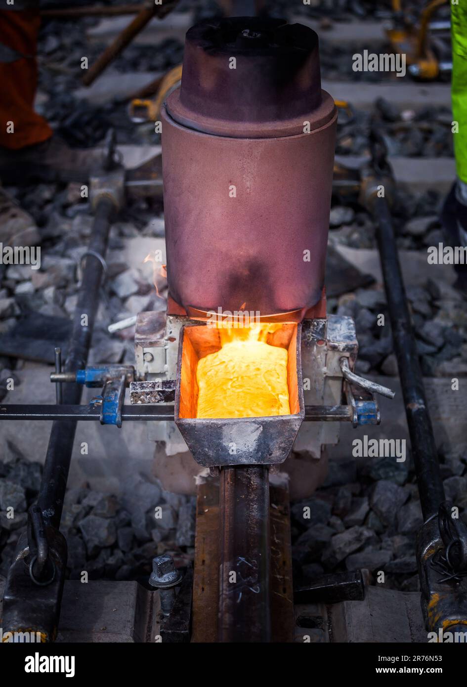 From above of burning and melting binding metal with metal barrels in ...