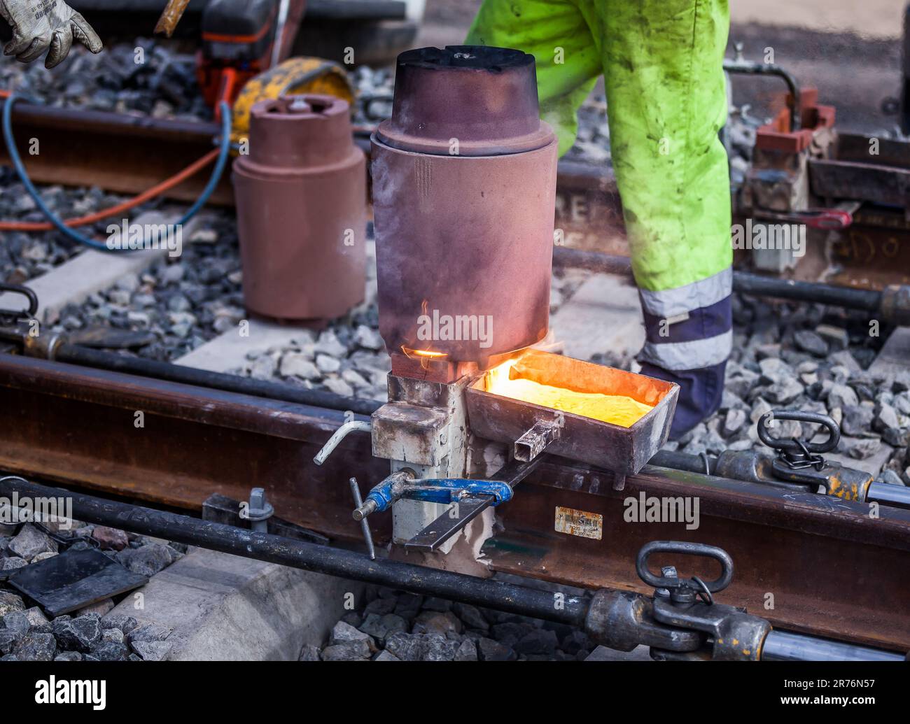 From above of burning and melting binding metal with metal barrels in ...