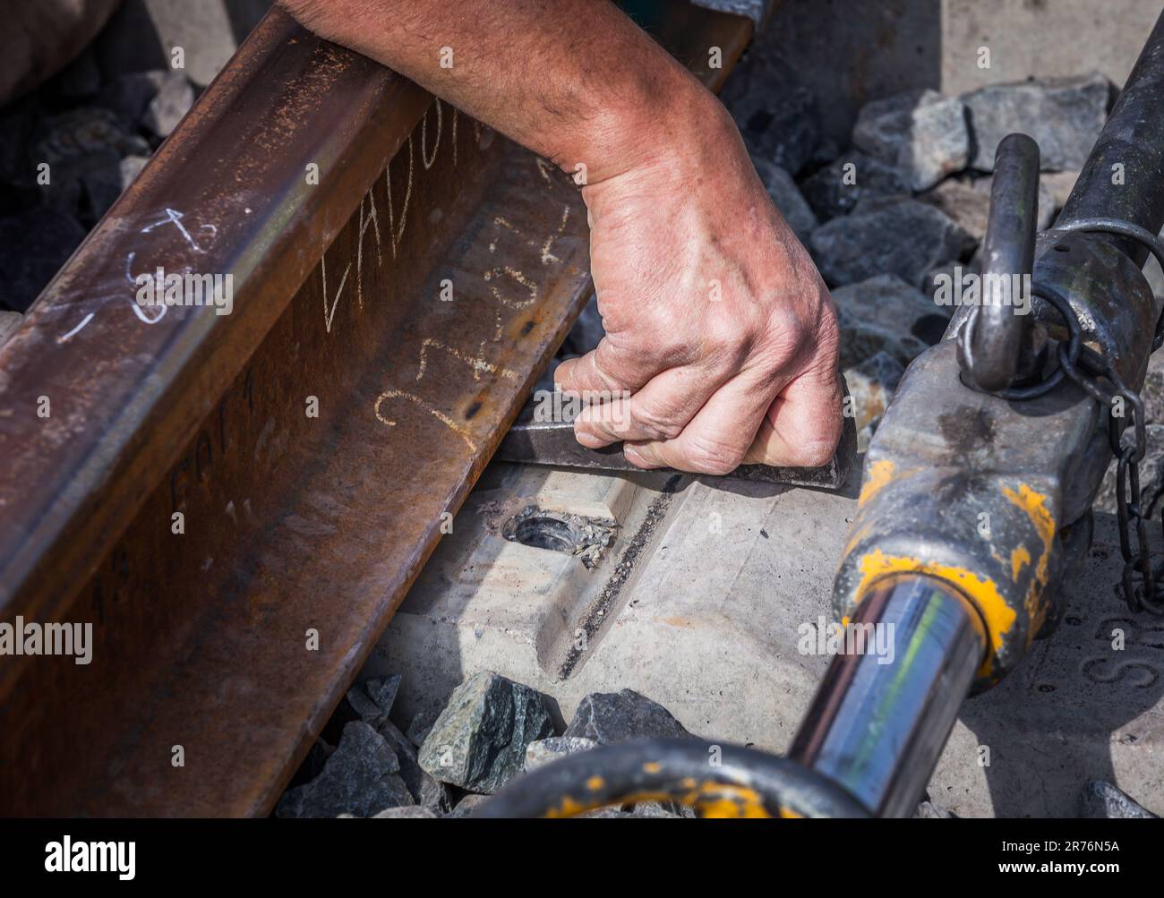 From above of crop anonymous male technician arranging and wedging ...