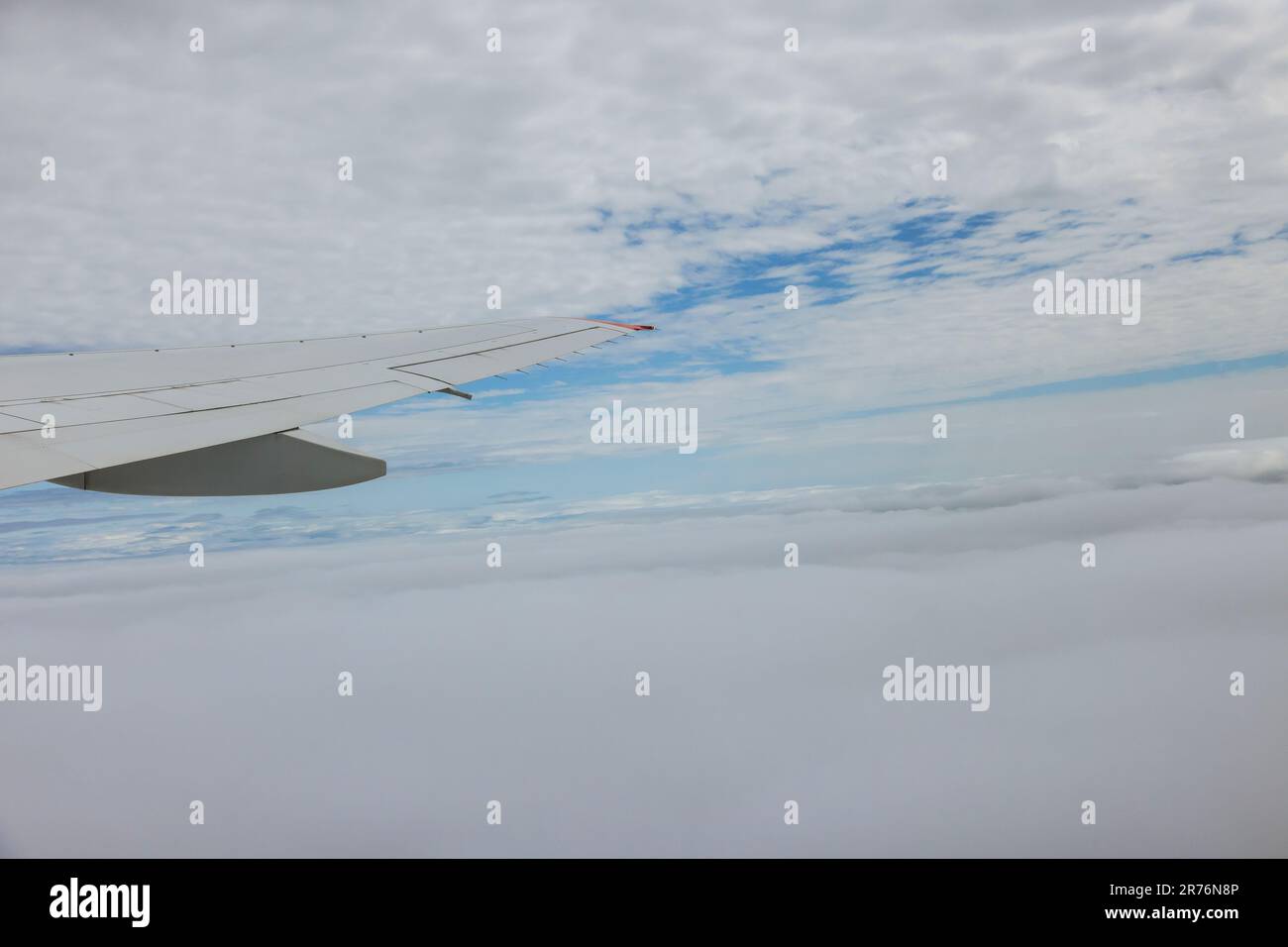 Airplane wing over clouds beautiful view through window of flying plane ...