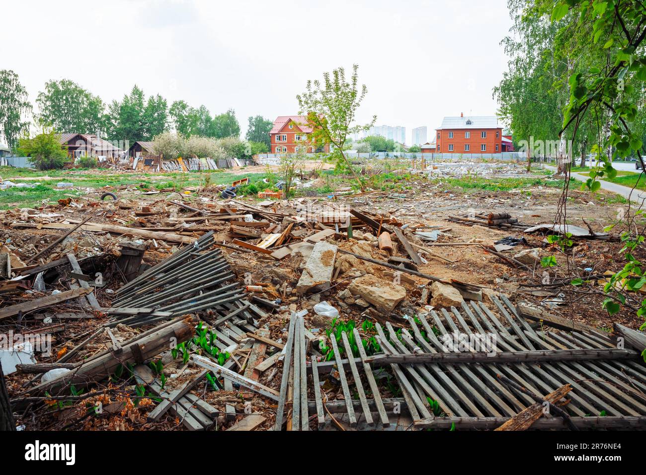 construction waste dump, broken wooden fence on wasteland. pile of ...