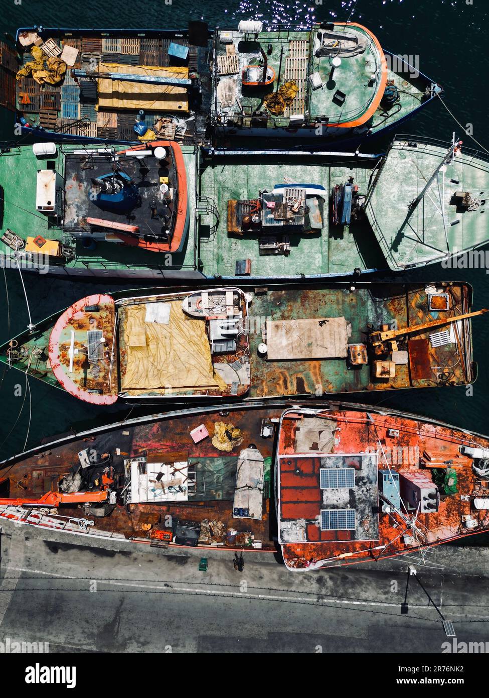 A fleet of boats moored in a harbor, lined up side by side Stock Photo ...