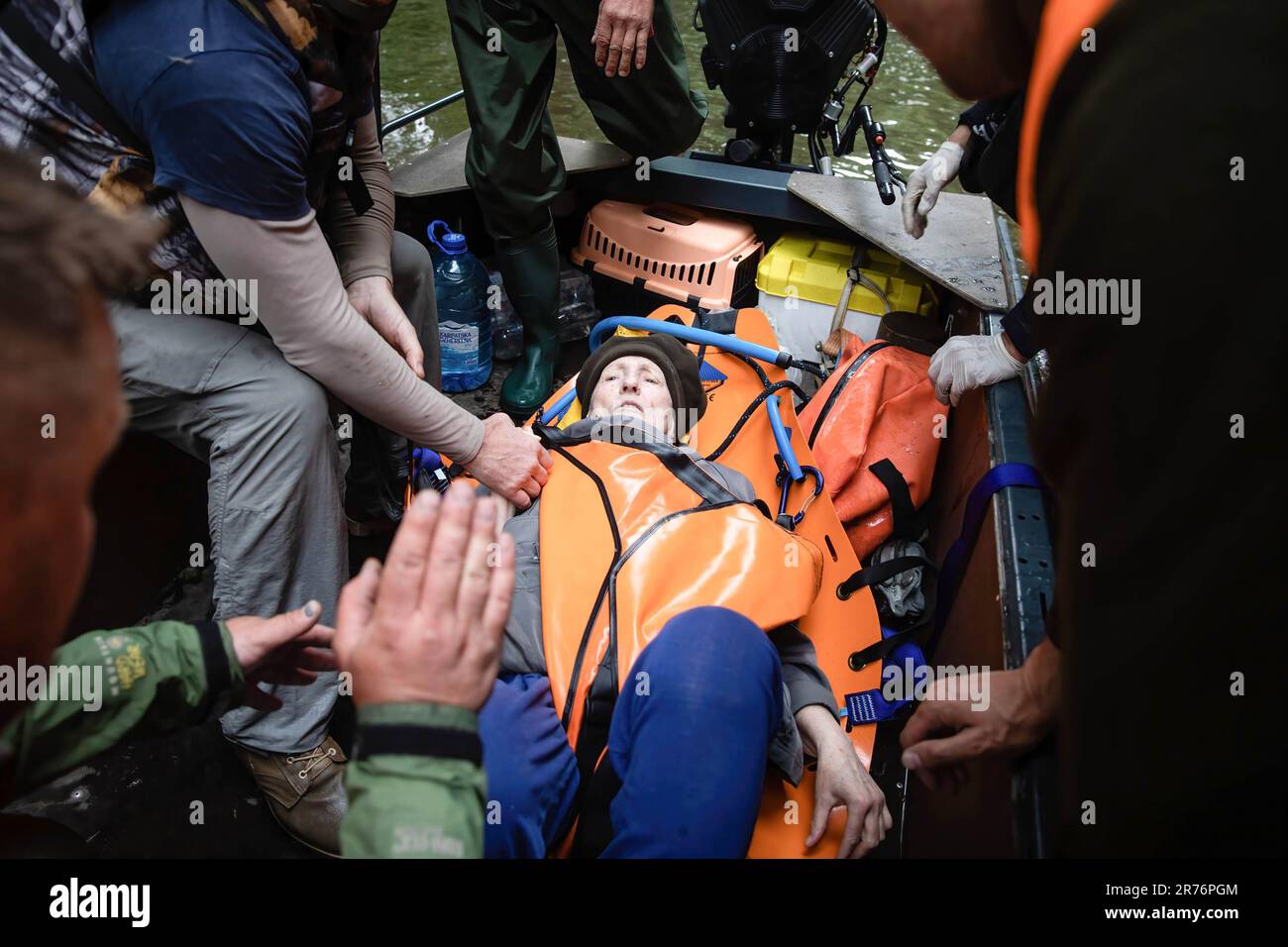 Lifeguards are seen evacuating an elderly helpless woman in a boat from ...
