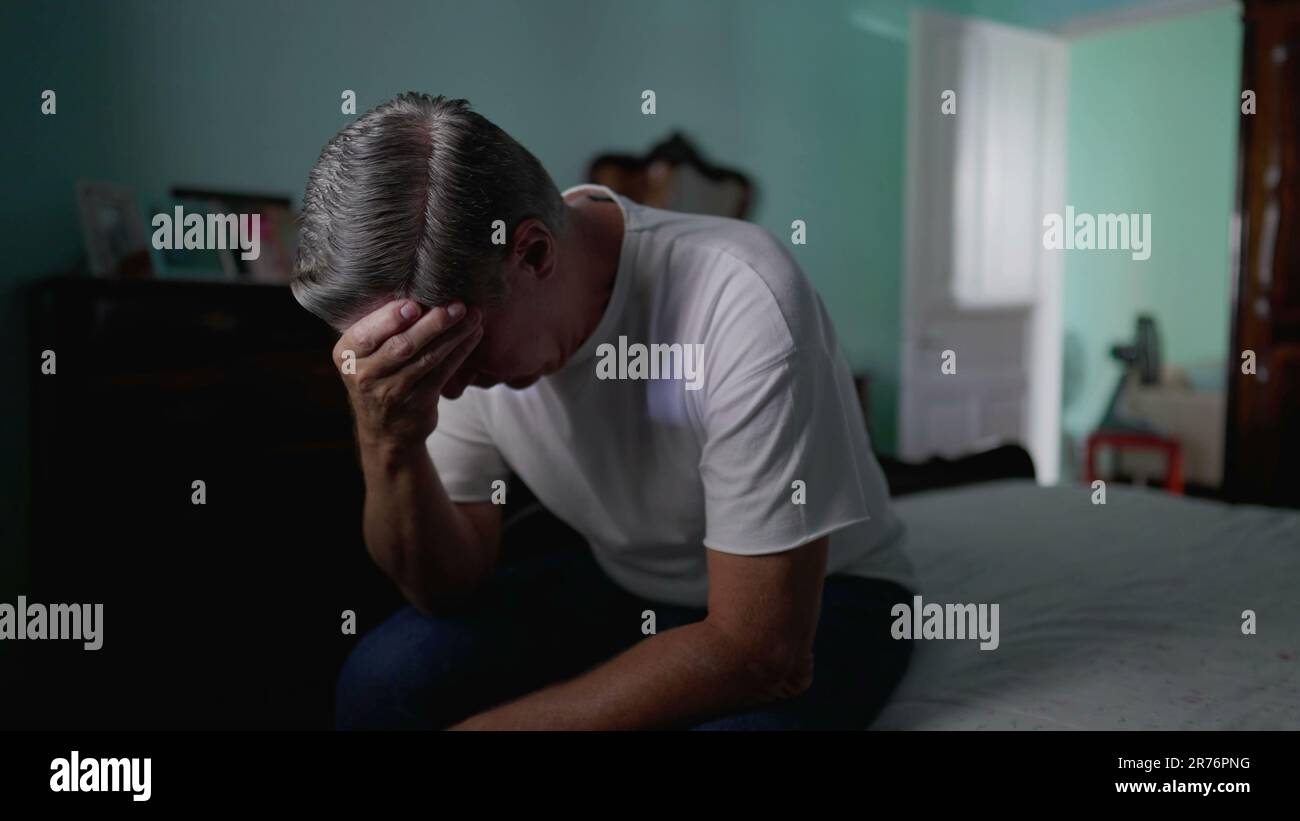 Anxious preoccupied older man sits by bedside feeling worry. Stressed ...