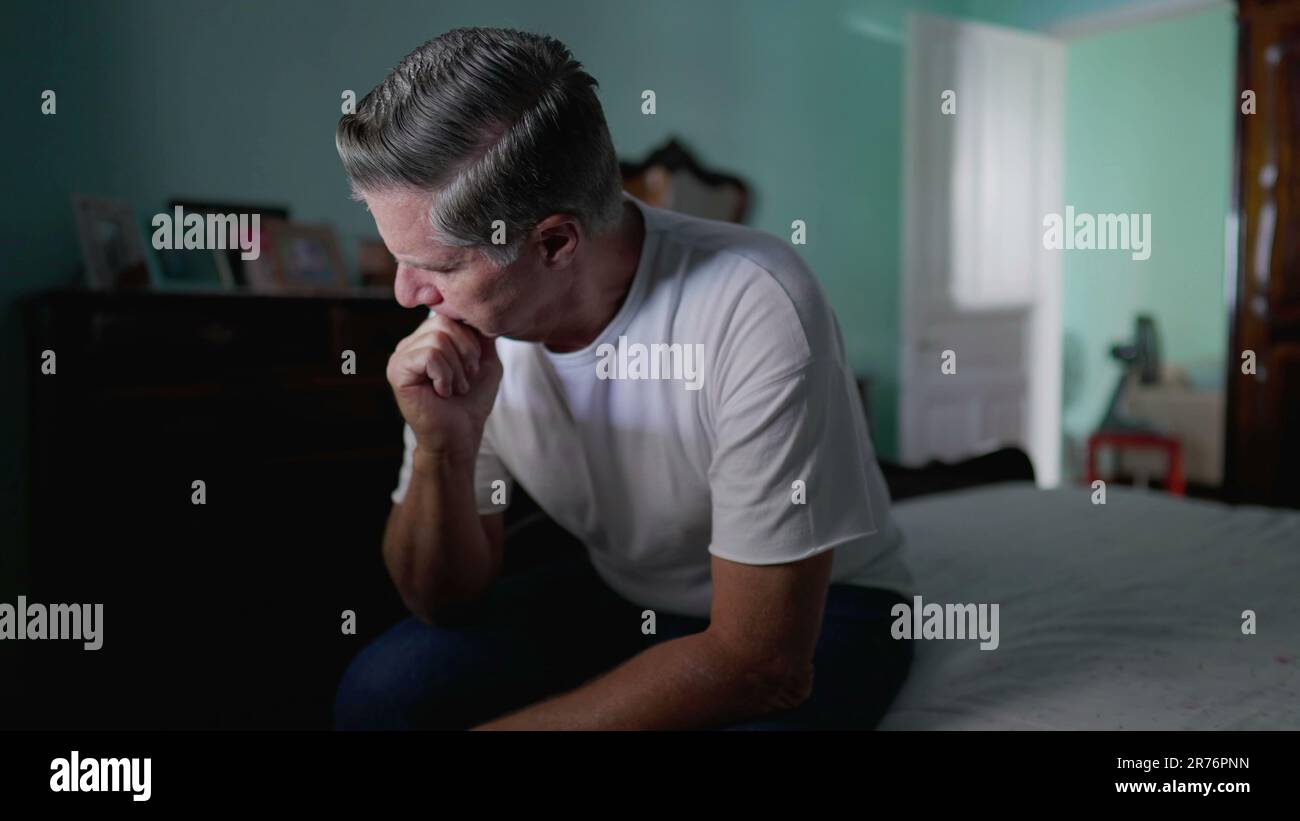 Anxious preoccupied older man sits by bedside feeling worry. Stressed ...