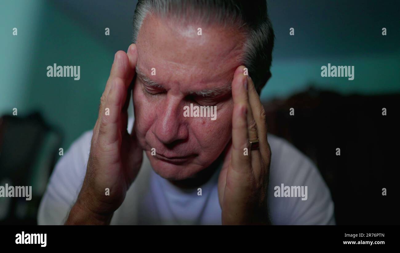 Close-up of a middle aged man suffering from headache, older person ...