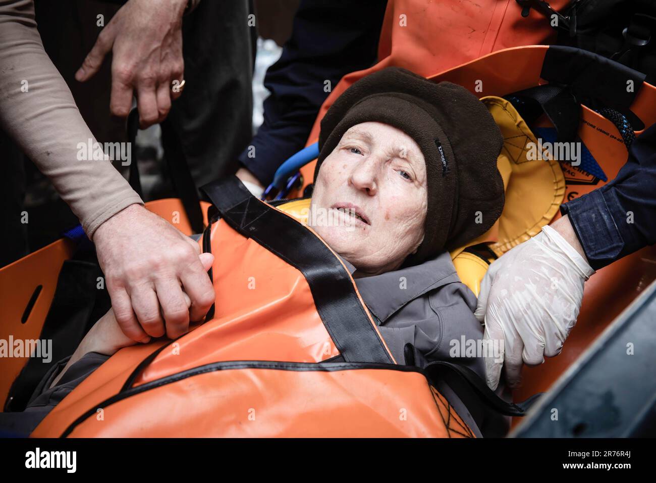 The rescued elderly helpless woman is seen in the rescue boat. The ...