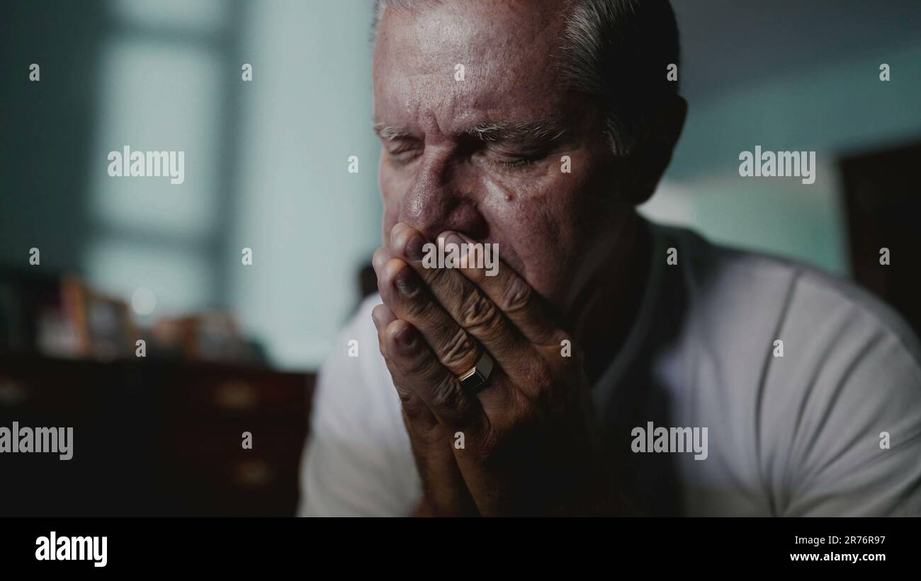 Preoccupied older man covering face in shame and anxiety. A male ...