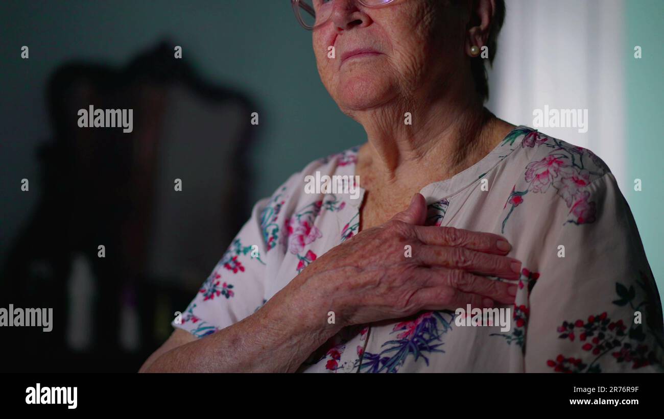 Religious Elderly woman doing Sign of the Cross. Catholic theme of ...